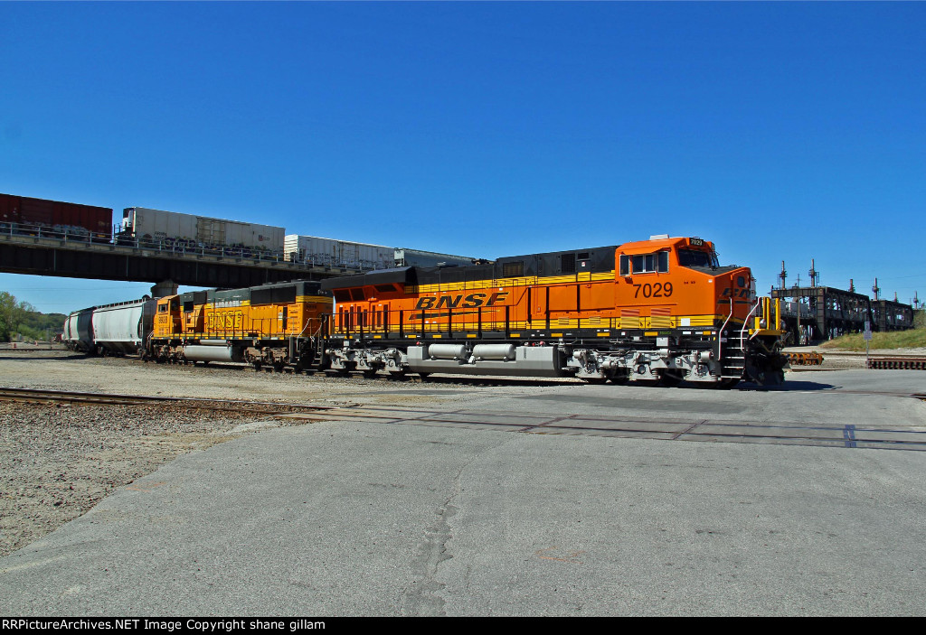 BNSF 7029 leads a freight Nb with a up EB flying above.